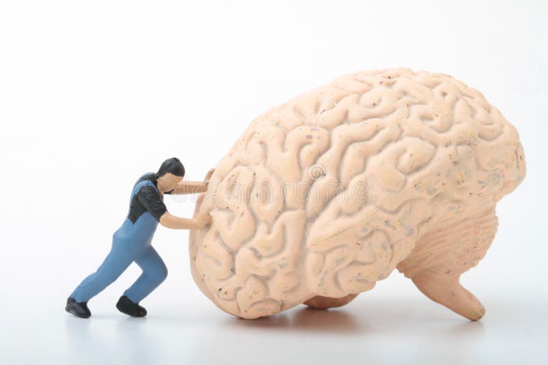 Miniature Figurine of a Man Pushing a Giant Brain Stock Photo - Image ...