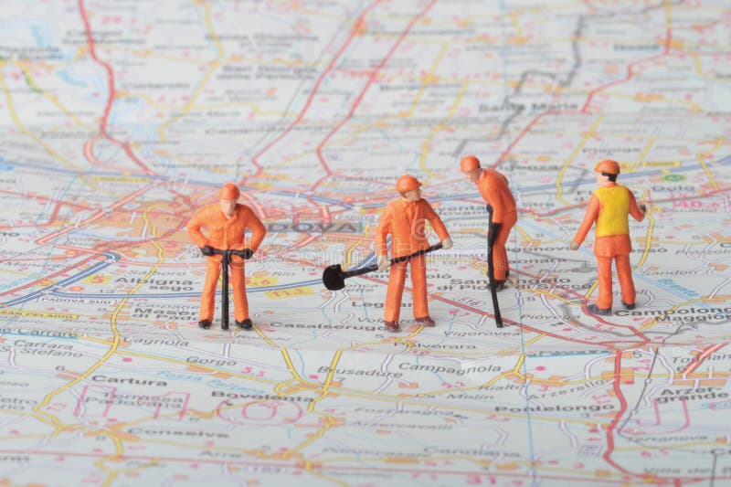 Miniature Figurines of a Team of Men at Work on a Road Map Stock Image ...
