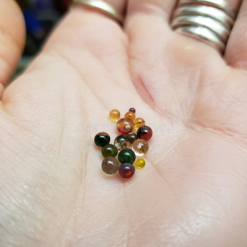 Miniature glass marbles stock photo. Image of finger - 240648534