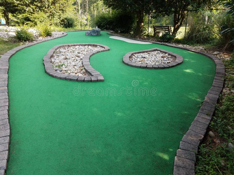 Miniature Golf Course Hole with Green Grass and Stones Stock Photo ...