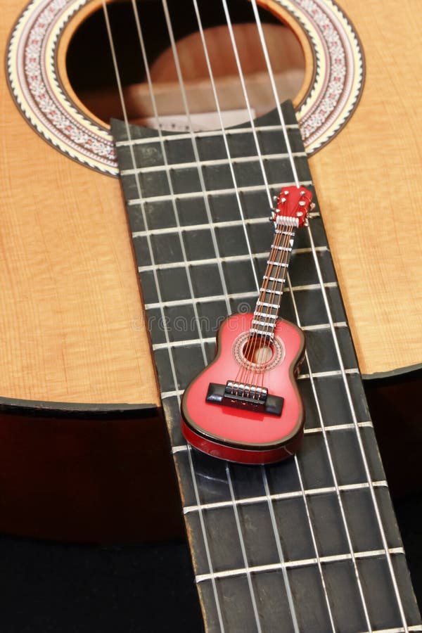 Miniature Guitar on Acoustic Guitar Stock Image - Image of instrumental ...