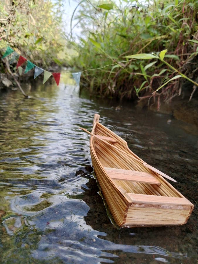 Miniature Handcrafted Rowboat on a Waterway Stock Photo - Image of lake ...