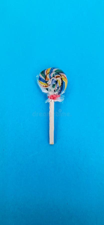 Miniature Handmade Tiny Lollipop on a Blue Background Stock Image ...