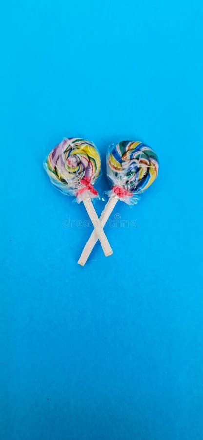 Miniature Handmade Tiny Lollipops on a Blue Background Stock Photo ...