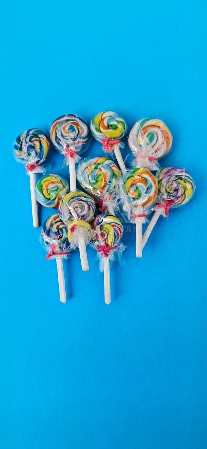 Miniature Handmade Tiny Lollipops on a Blue Background Stock Image ...