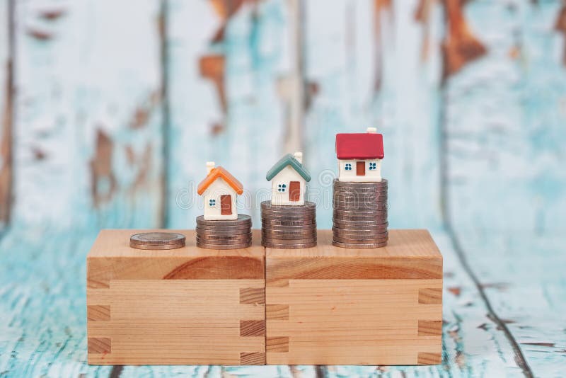 Miniature House on Coin Stack on Wood Stand with Wall Stock Photo ...
