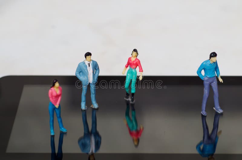 Miniature Little People, Friends at Outdoors Over a Screen of a Tablet ...