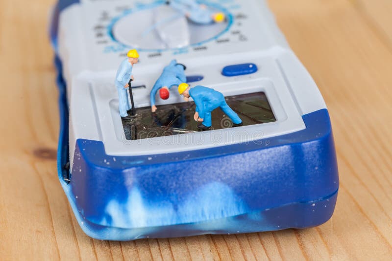 Miniature Maintenance Team Repairing a Broken Multimeter Stock Image ...