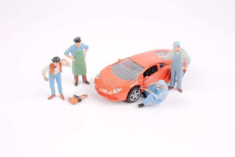 Miniature Mechanics Working on a Car Stock Image - Image of orange ...