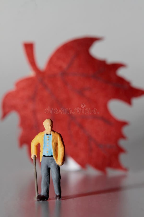 Miniature of an Old Man with a Fall Leaf on the Background Stock Photo ...