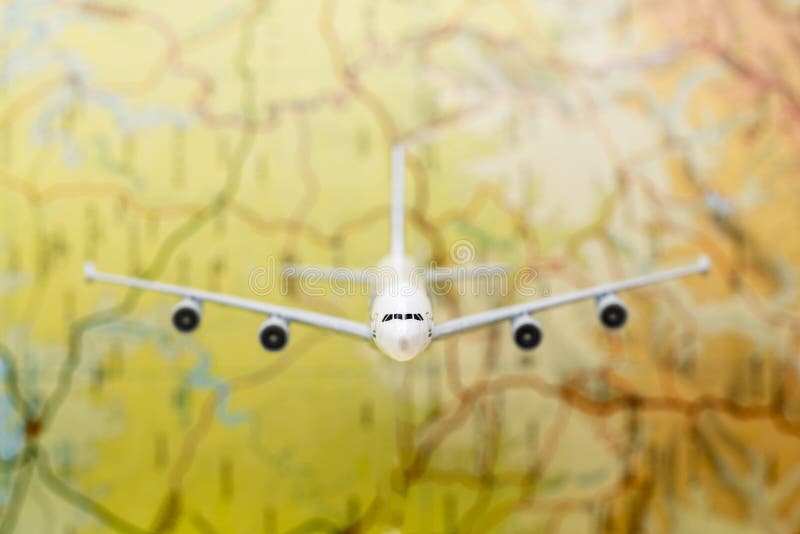 Miniature Passenger Plane Flying Over a Blurred Map Stock Image - Image ...