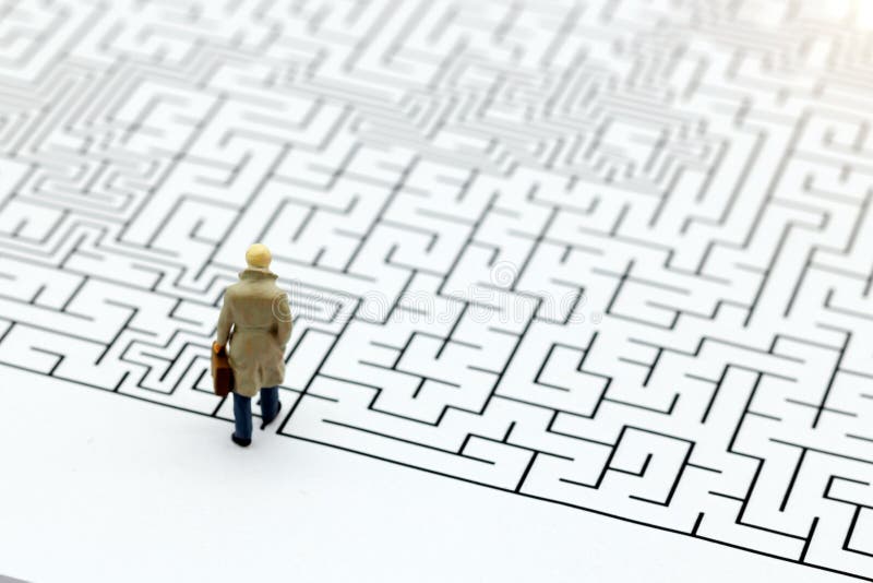 Miniature People: Businessman Standing on Start of Maze. Stock Image ...