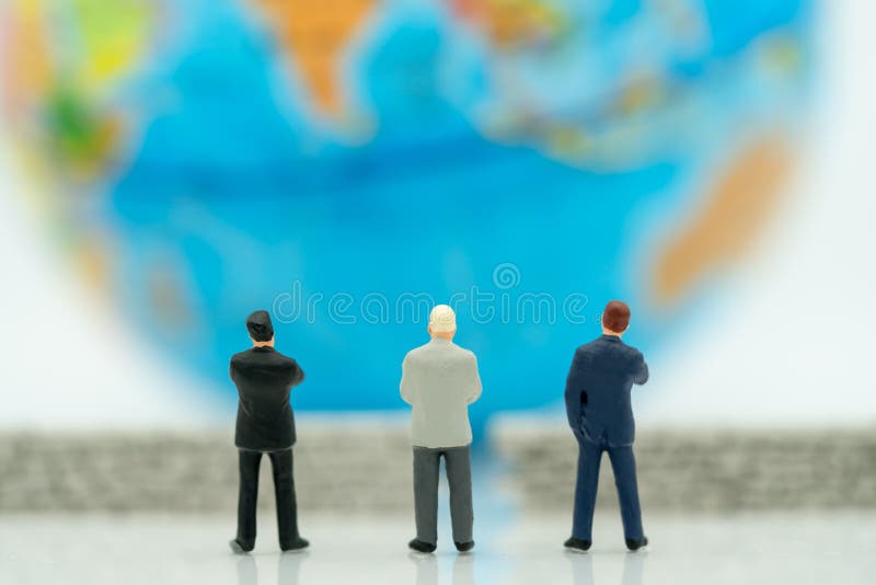 Miniature People: Businessman Standing with Wall and World. Concepts of ...