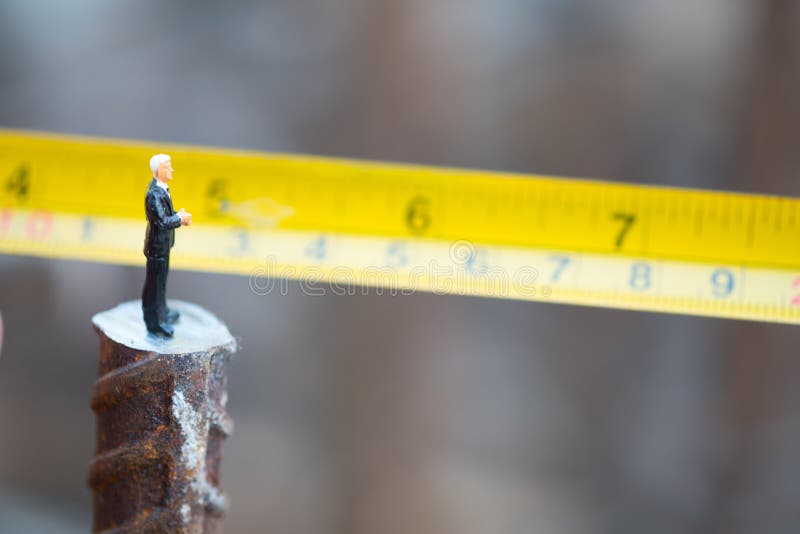 Miniature People: Businessman Thinking and Standing at Construction ...