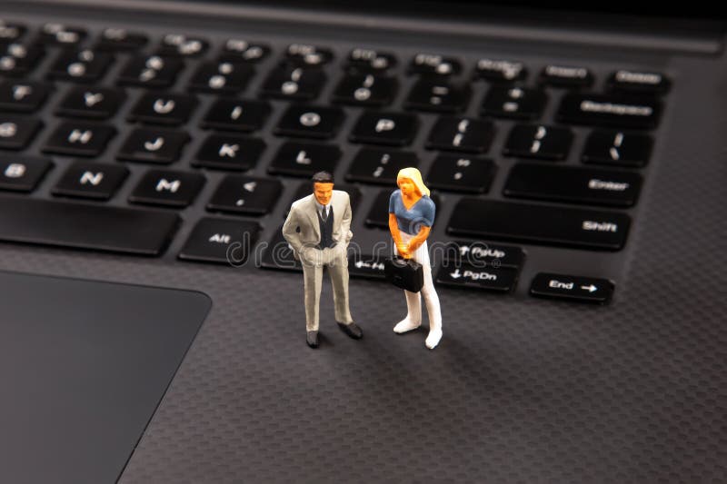Miniature People. Figures of Business People Stand on a Laptop Keyboard ...