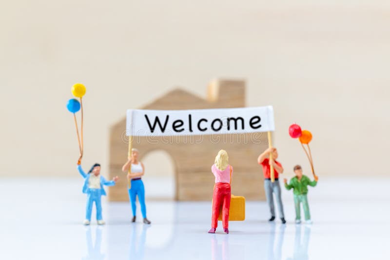 Miniature People Holding Welcome Signs at Front of the Home Stock Photo ...