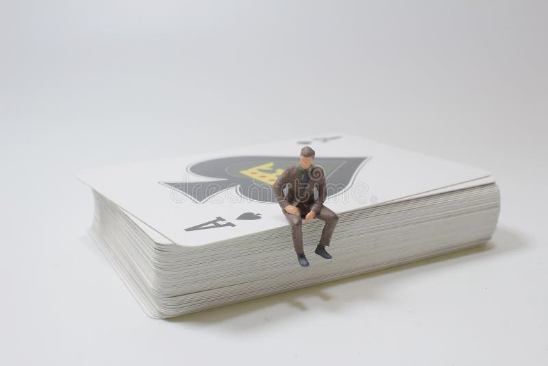 A Miniature People, Man Sitting on Playing Cards Stock Image - Image of ...