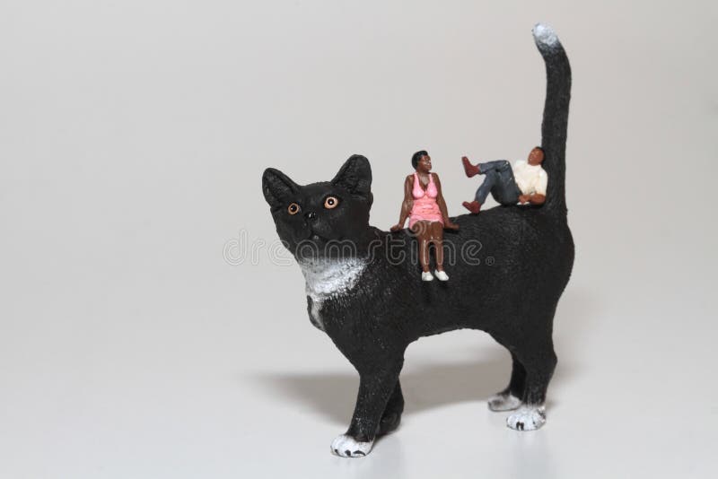 Miniature of People Sitting on a Giant Black Cat Stock Image - Image of ...