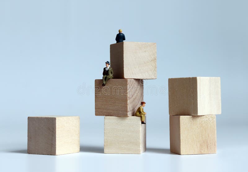 Miniature People Sitting on Stack of Wooden Blocks. Stock Image - Image ...