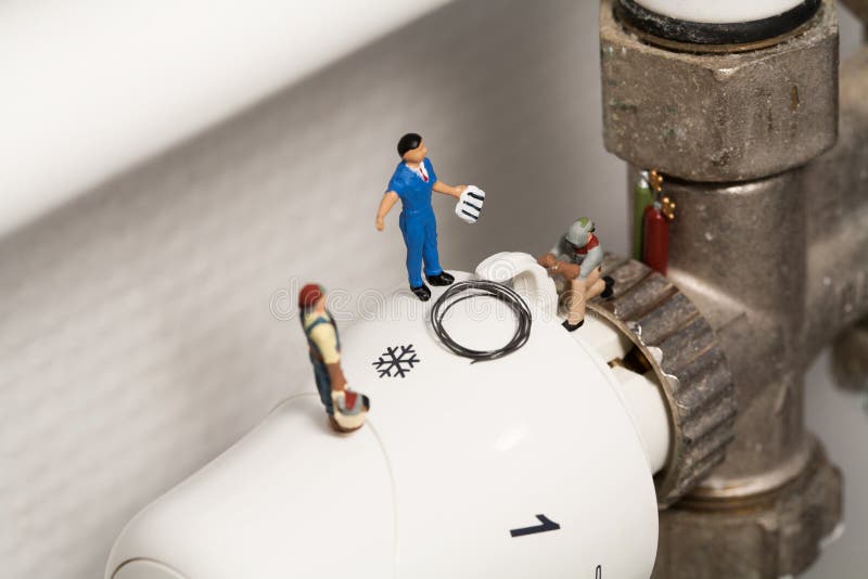 Miniature Plumbers Repairing a Thermostat Stock Photo - Image of repair ...