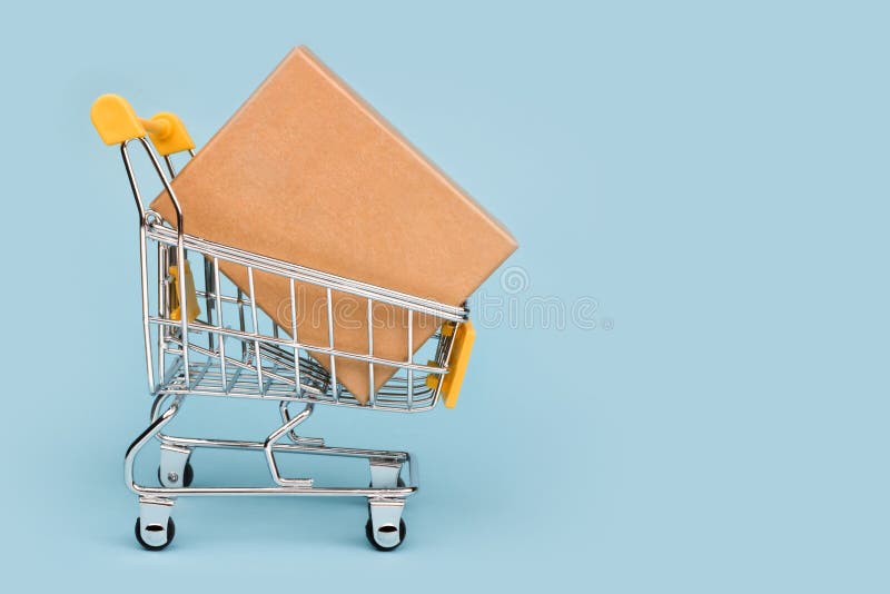 Miniature Shopping Cart with Large Box Isolated on Blue Background ...
