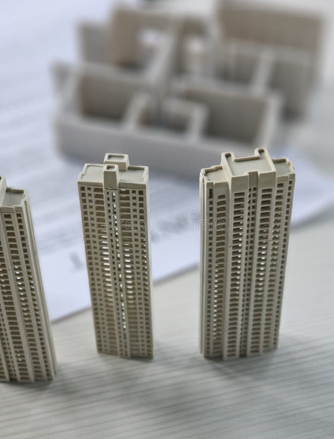 Miniature Skyscrapers Displayed on a Desk with Architectural Plans ...