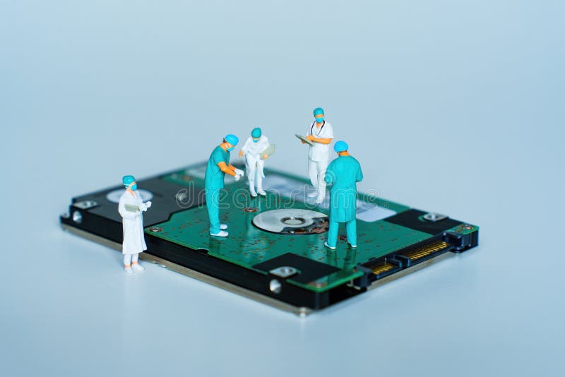 Miniature Surgeons Performing Data Surgery on Hard Drive Stock Image ...