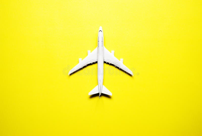 Miniature Toy Airplane on Yellow Background. Trip by Airplane Stock ...