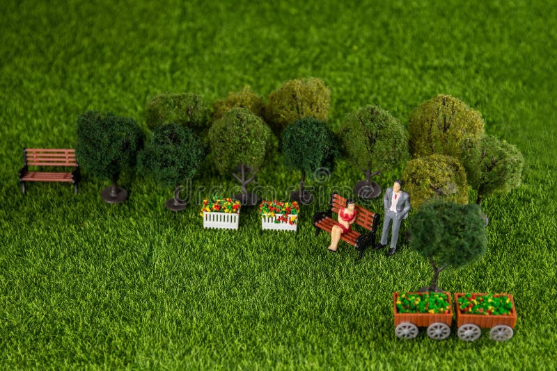 Miniature Toy of a Woman and Man Surrounded by Trees in a Park Stock ...