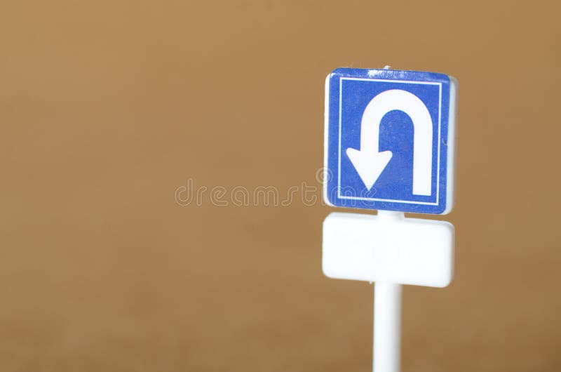 Miniature U-Turn Sign on Brown Background â€ Traffic Direction Concept ...