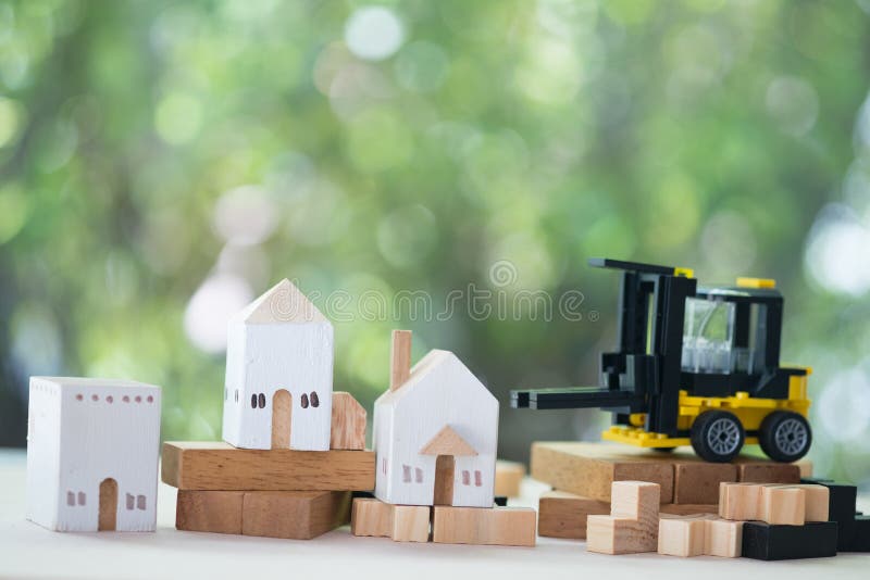 Miniature Wooden House Models with Miniature Yellow Forklift on Wooden ...