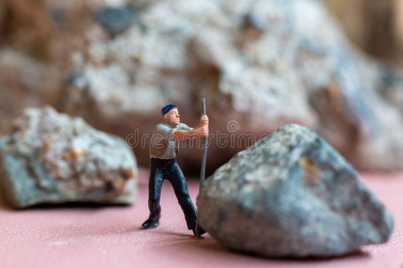 Miniature Worker Pushing a Large Rock. Themes of Perseverance, Strength ...