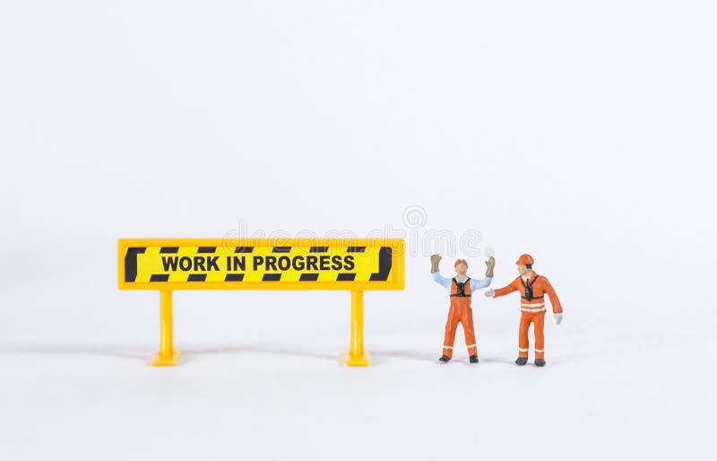 Miniature Worker with Work in Progress Sign Isolate on White Background ...