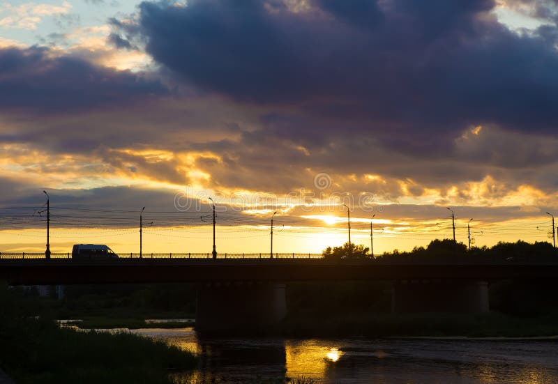Minibus Moves through the Bridge in the Evening at Sunset Stock Photo ...