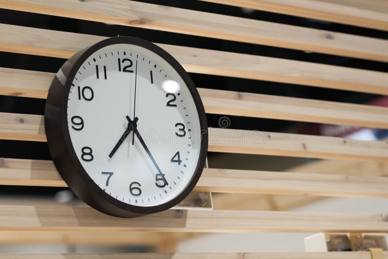 Minimal Style Black and White Clock Hanging on Wood Wall Stock Image ...