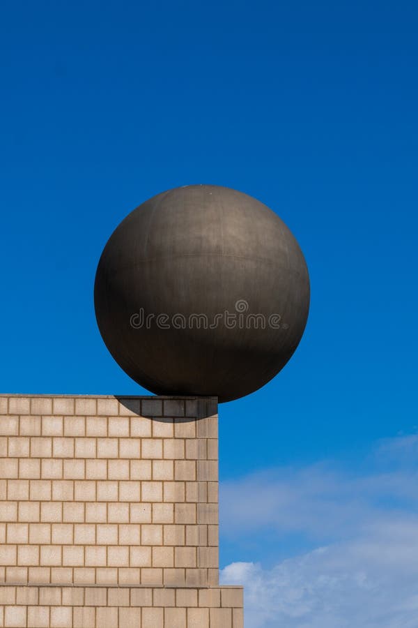 A Minimalist Architectural Design Featuring a Large Sphere Balanced on ...