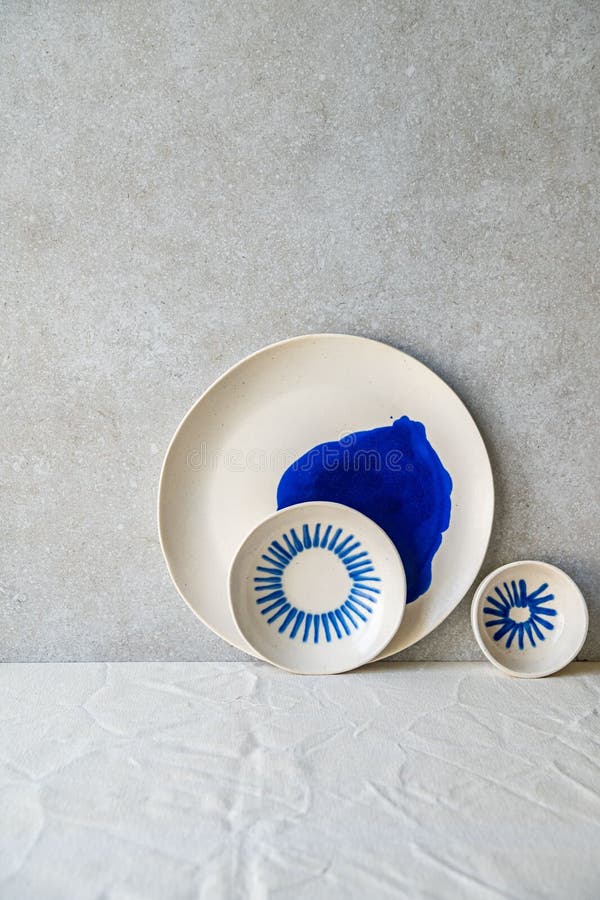 Minimalist Ceramic Plates with Blue Abstract Designs on a Textured ...