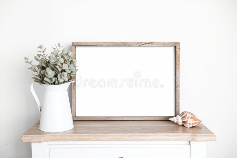Minimalist Decor with Empty Frame, Greenery, Shell, and Simple Wooden ...