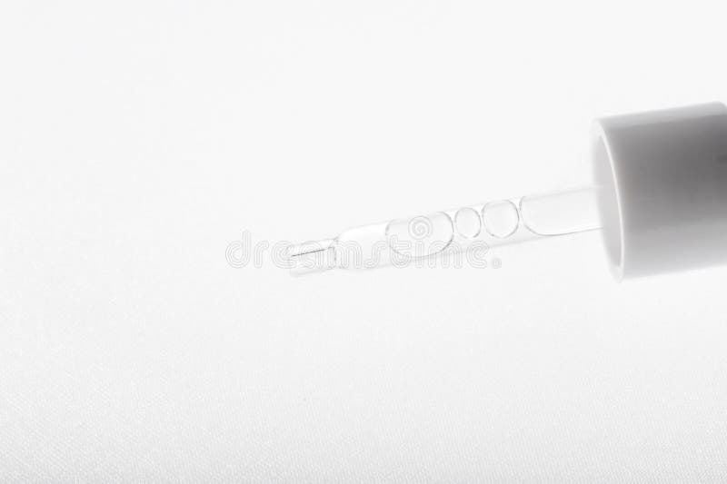 Minimalist Dropper with Transparent Liquid on White Background. Stock ...