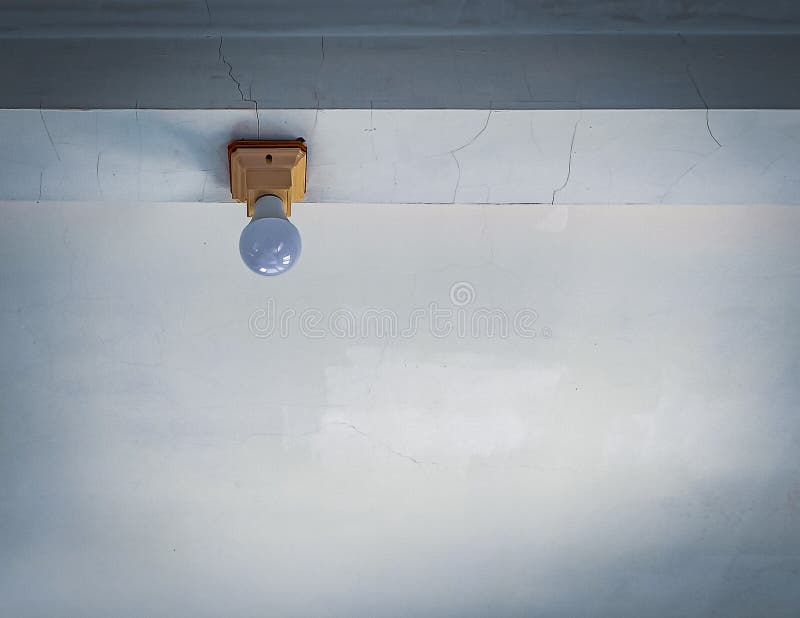 Minimalist Light Bulb Attached To a Cracked Ceiling Surface Stock Photo ...