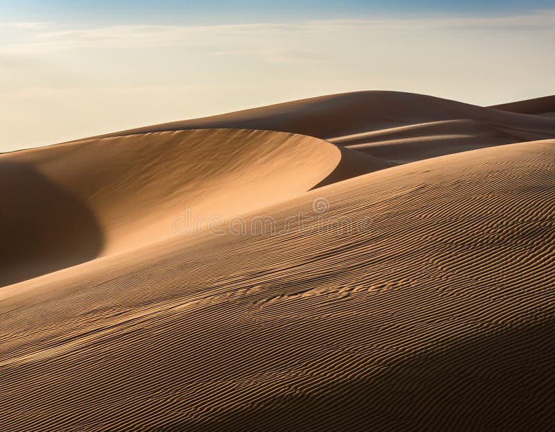 Minimalist Sand Dunes with Flowing Lines and Soft Shadows Creating a ...