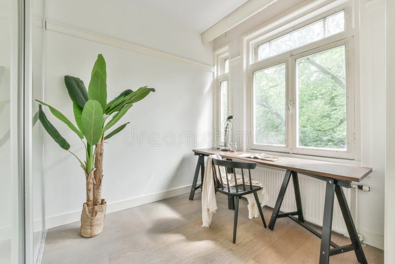 Minimalist Style Working Room with Table, Chair, and Houseplant Stock ...