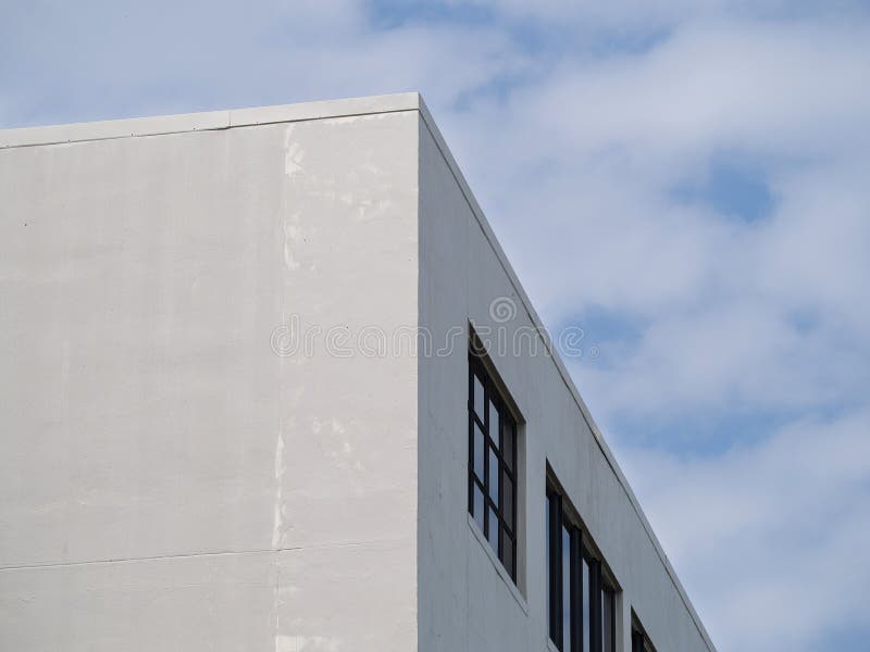 Minimalist White Building Corner and Black Windows Against Cloudy Sky ...