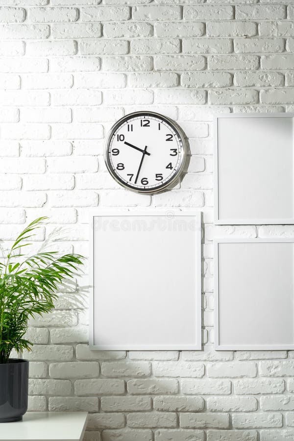 Minimalist White Wall Display with Clock and Empty Frames in a Modern ...