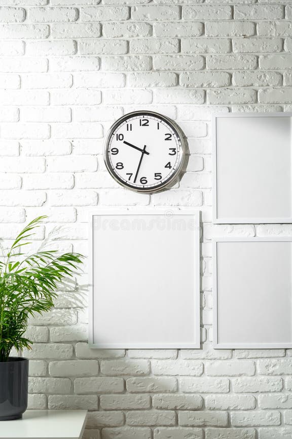 Minimalist White Wall Display with Clock and Empty Frames in a Modern ...