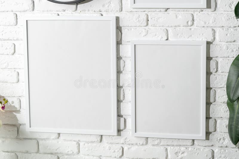 Minimalist White Wall Display with Clock and Empty Frames in a Modern ...