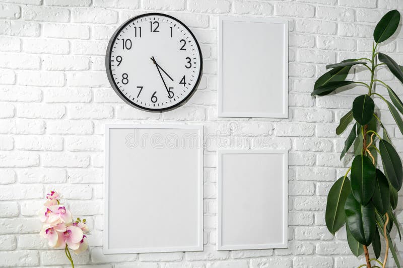 Minimalist White Wall Display with Clock and Empty Frames in a Modern ...