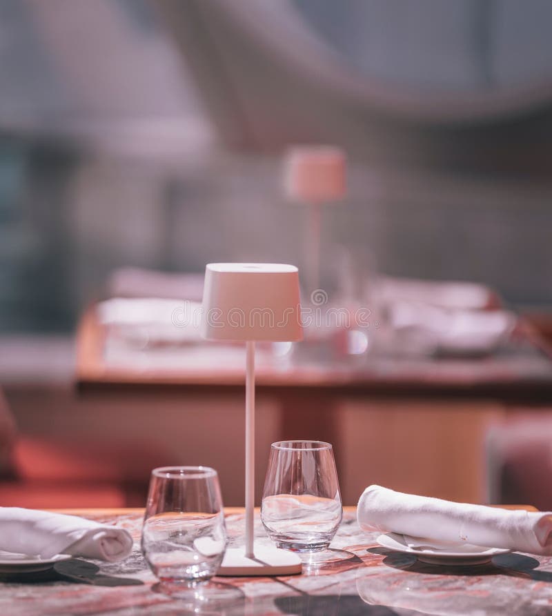 A Simple Table Setting with Glass Cups and a Lamp Stock Photo - Image ...