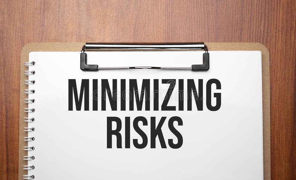 Minimizing Risks Text on White Paper on the Wood Table Stock Image ...
