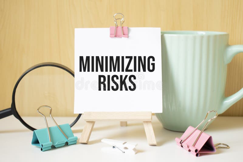 Minimizing Risks Text Written on Black Notebook with Magnifying Glass ...